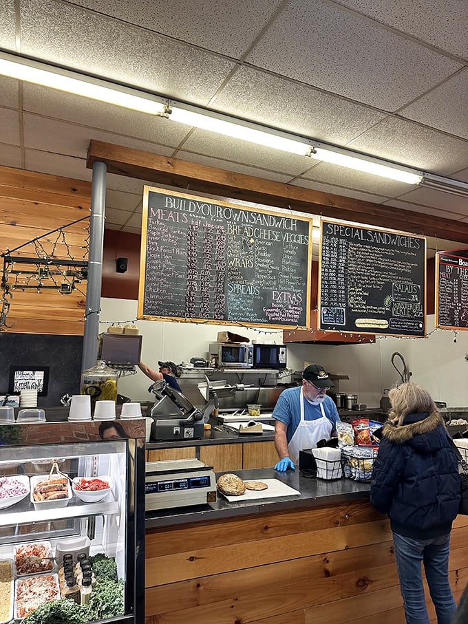 Sandwich artistry in action! Watch as these culinary maestros compose edible symphonies, their chalkboard menu a tantalizing promise of delights to come.