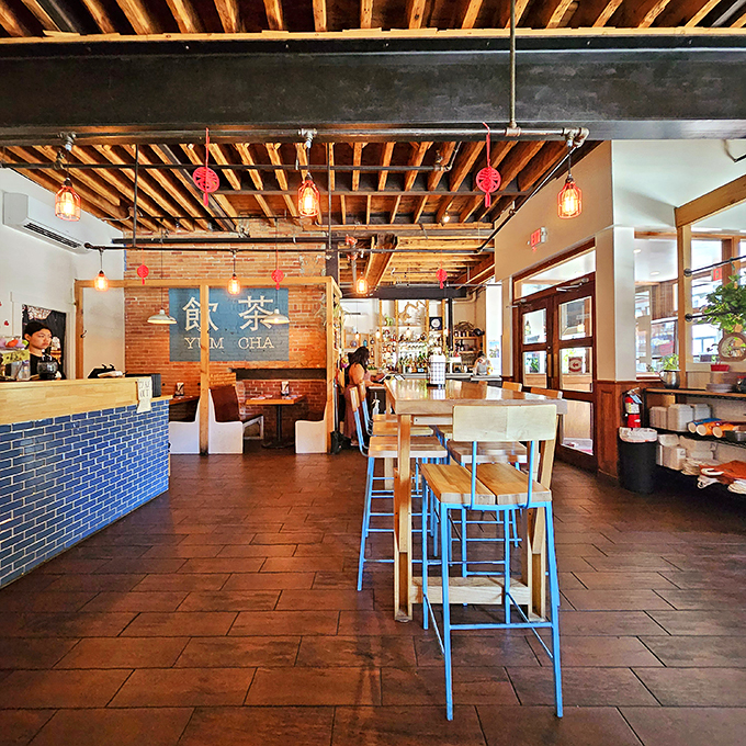 Exposed beams, pendant lights, and blue chairs - oh my! This dining room is cozier than a panda's bamboo nook.
