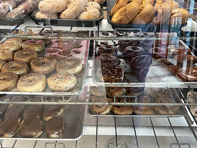 Donut nirvana achieved! From classic rings to fancy fritters, this case holds more circles of joy than a geometry textbook.