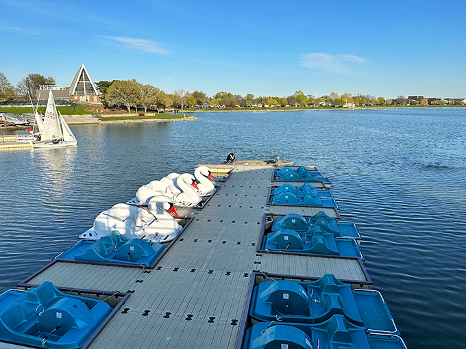 The A-frame pavilion watches over a flotilla of swan boats, looking like a whimsical summer camp for waterfowl enthusiasts.
