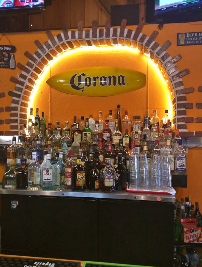 Behind this glowing arch of spirits, margarita magic happens. The Corona surfboard adds a perfect touch of beach-meets-woods charm.