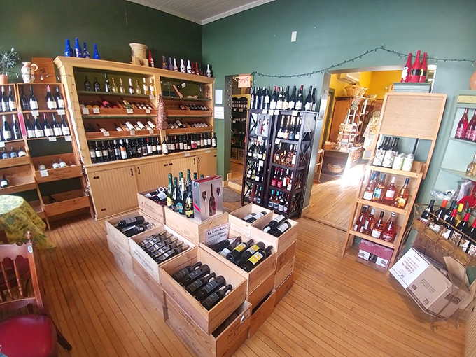 The wine room is a treasure trove of carefully curated bottles, where French vintages mingle with local favorites in rustic wooden displays.