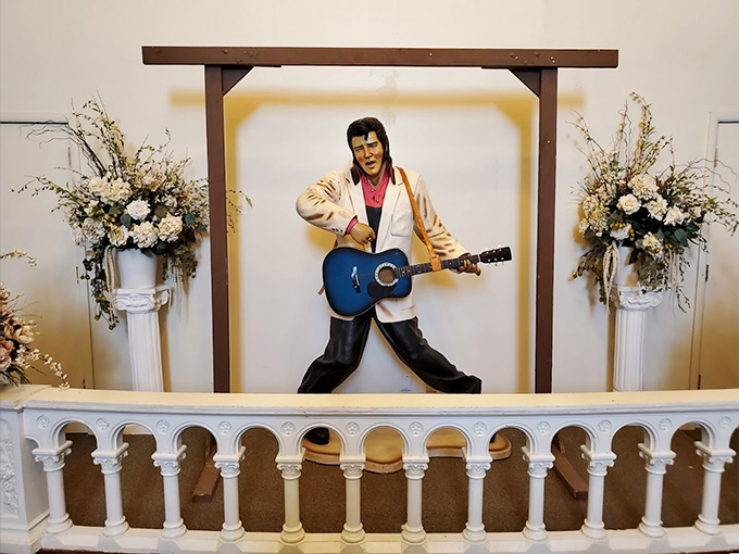 The King lives on at the altar, complete with his signature stance and a blue guitar that would make Memphis proud. 