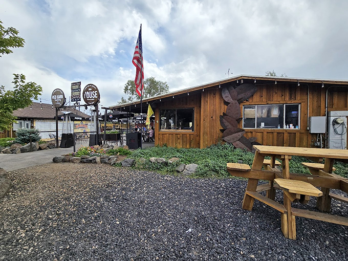 This isn't just a restaurant; it's a slice of Americana. The red barn, the flag, the promise of good eats &ndash; it's like Norman Rockwell painted a steakhouse.