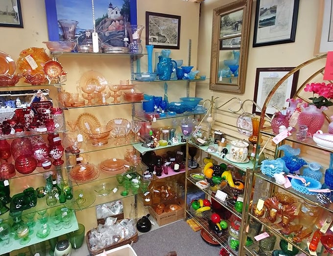 A rainbow explosion of vintage glassware transforms ordinary shelves into a kaleidoscope of memories and possibilities.