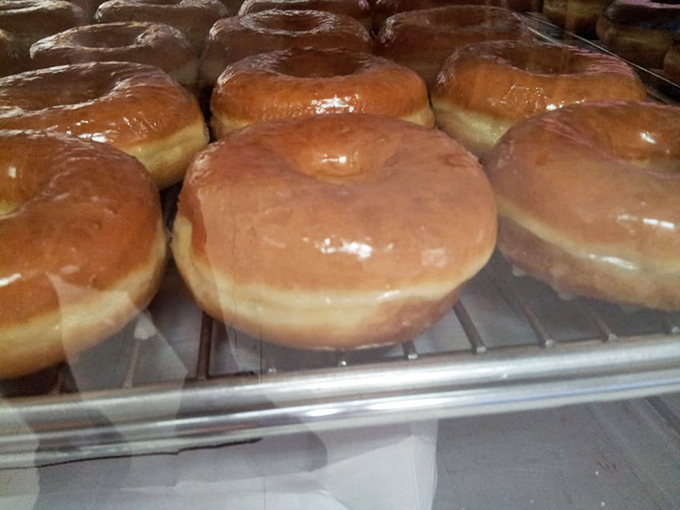These glazed beauties glisten under the display lights, each one promising that perfect melt-in-your-mouth moment.