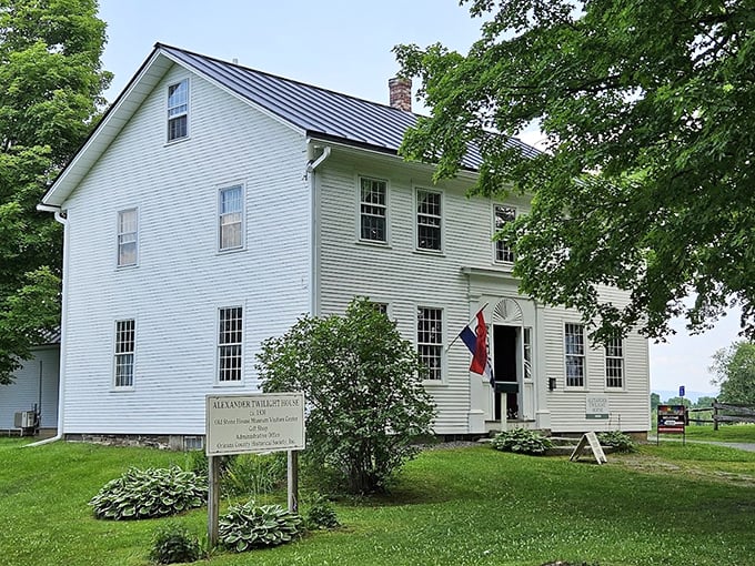 The Alexander Twilight House welcomes visitors with Federal-style grace, its white clapboard exterior gleaming like fresh Vermont snow.