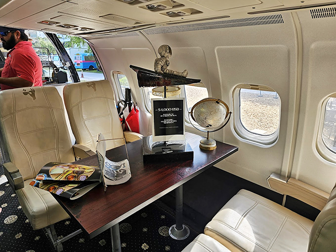 Globes and vintage travel memorabilia transform this aircraft cabin into a whimsical escape for coffee lovers and adventurers alike.