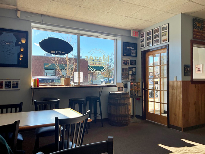 Sunlight streams through large windows, illuminating a space where local photos and barrel accents tell stories of community connections.