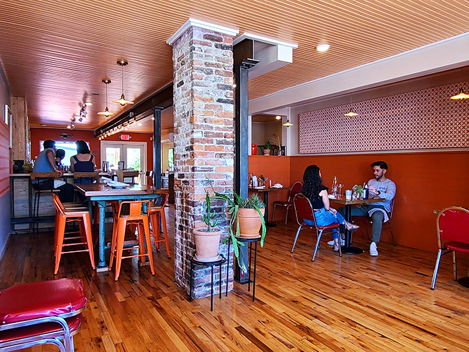 Exposed brick pillars and geometric orange walls create a space that feels like Austin met Portland for coffee and decided to stay. Photo credit: Wil Snodgrass