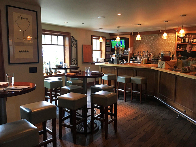 Modern meets cozy in this sophisticated bar area, where pendant lights cast a warm glow over leather-topped stools.
