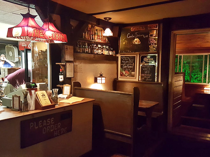 Warm wood paneling and vintage lamps create the kind of cozy atmosphere that makes you want to settle in for the evening.