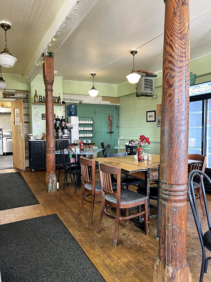 Rustic wooden beams and mint-green walls create a cozy atmosphere that feels like stepping into a beloved maritime novel.