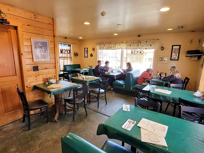 Pine-paneled walls and checkered curtains create the perfect backdrop for comfort food conversations and hometown memories.