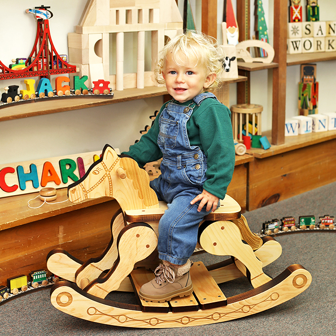 Wooden treasures line every shelf, from rocking horses to train sets, creating a wonderland that would make Santa's elves jealous.
