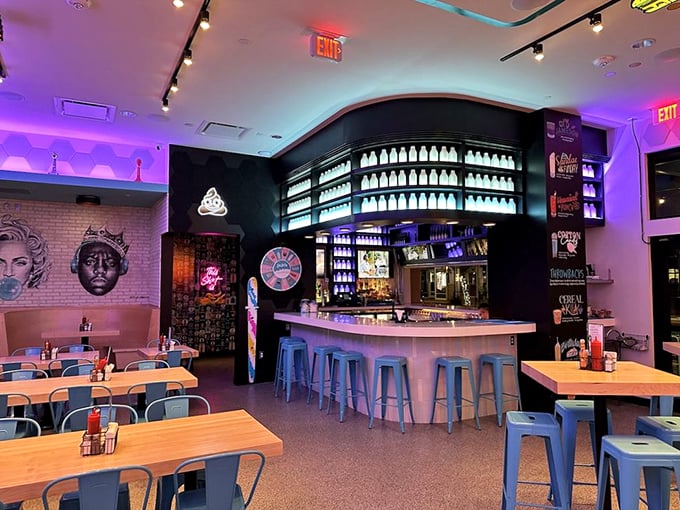 The illuminated bottle display and neon accents transform this bar into what feels like a scene from "Cocktail" meets "Stranger Things."