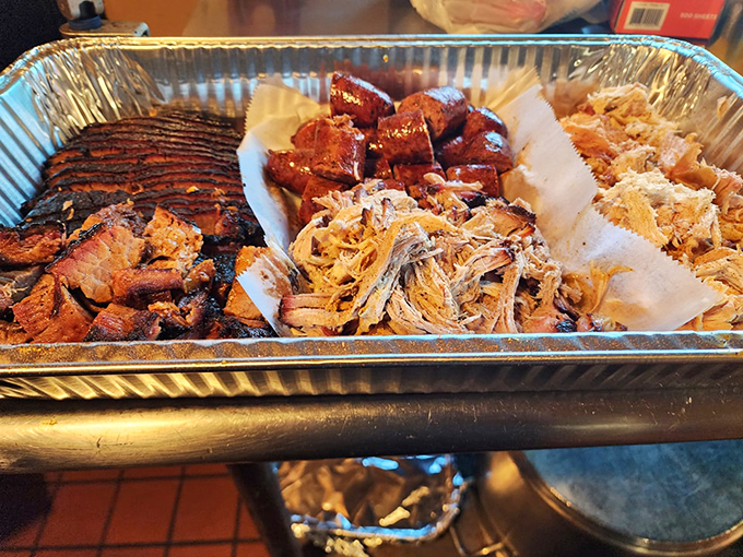 A barbecue trinity that would make any pitmaster proud: brisket, burnt ends, and pulled pork, each competing for your attention.