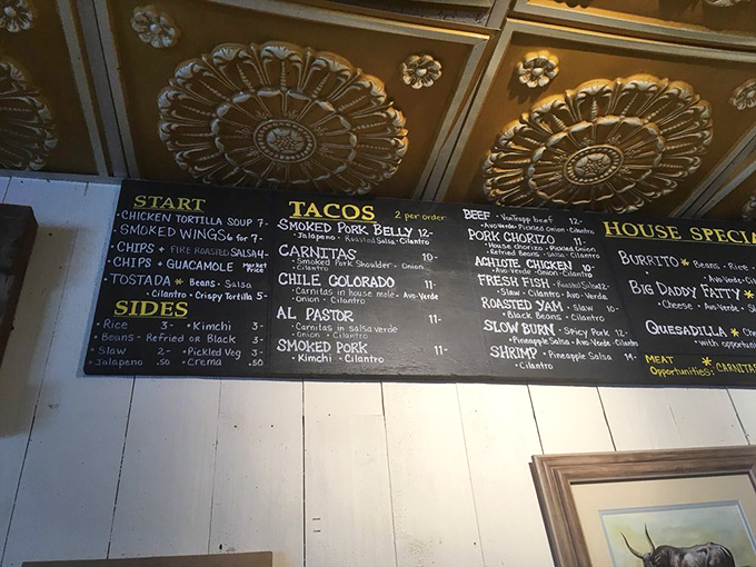Decisions, decisions! The Mad Taco's menu board is like a love letter to smoked meats and Mexican flavors. Prepare for some delicious dilemmas.