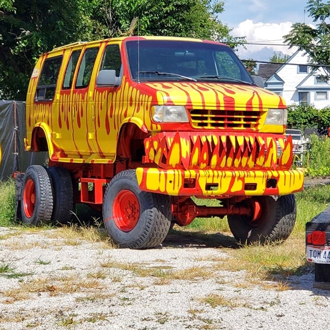 "When your morning commute requires conquering small mountains." This flame-adorned behemoth makes rush hour traffic look like a monster truck rally waiting to happen.