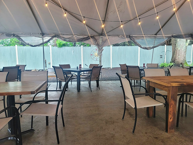 String lights twinkle above the outdoor patio, creating a magical summer dining space perfect for those warm Maine evenings. Photo credit: Teale Betts