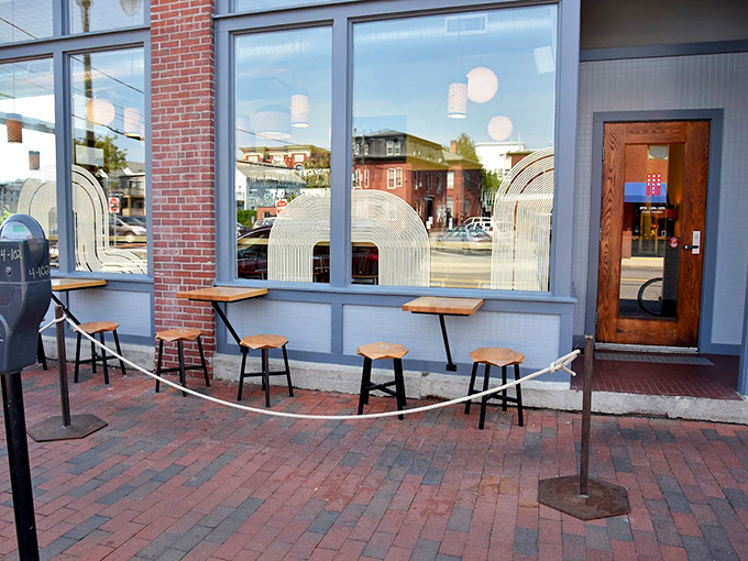 Window-side seats offer prime people-watching real estate, with those distinctive arched window designs adding a touch of retro-modern flair. Photo credit: The Honey Paw