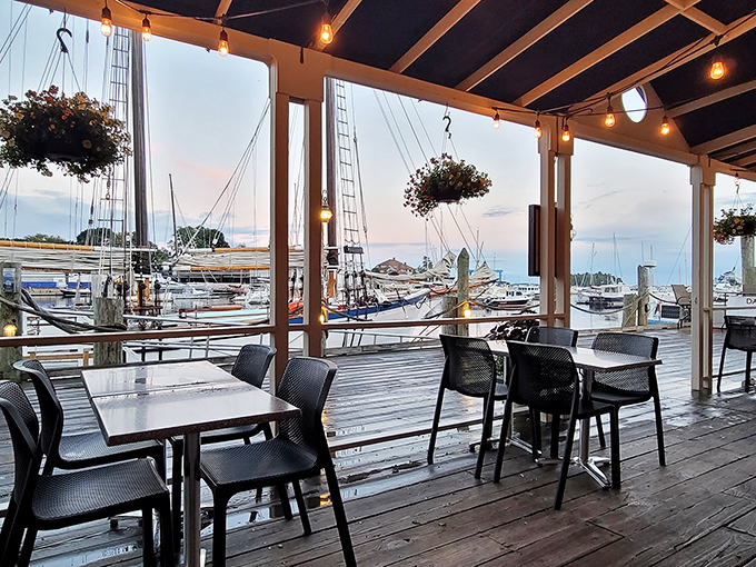 String lights twinkle above the waterfront deck as boats bob gently in Camden Harbor &ndash; dinner and a show, Maine style.