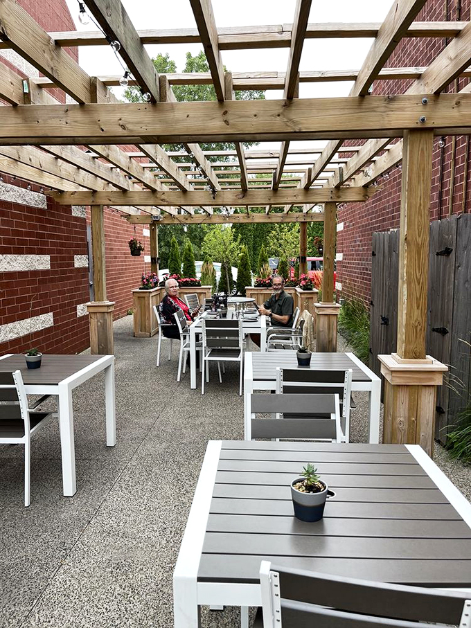 A pergola-covered patio that feels like your stylish neighbor's backyard, complete with planters that add just the right touch of green.