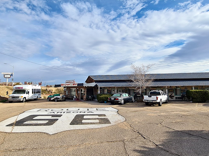 Get your kicks on Route 66! This painted road sign is more than asphalt art - it's your invitation to cruise into a bygone era of American road trips. 