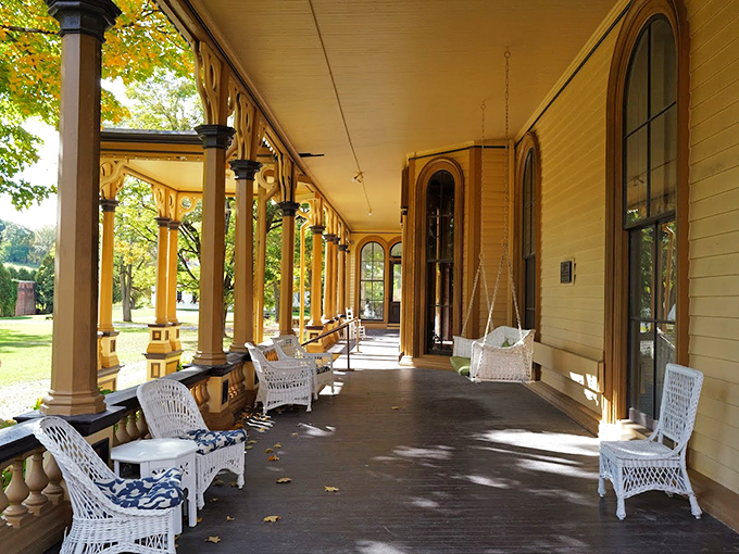 White wicker chairs invite visitors to channel their inner aristocrat while enjoying views that would make Downton Abbey jealous.