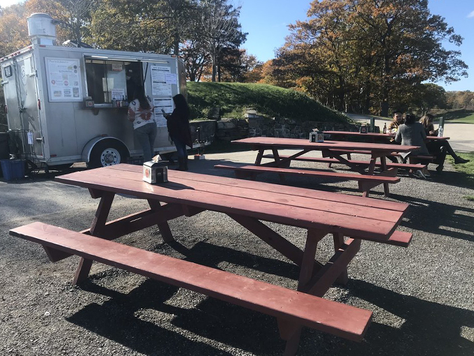 Red picnic tables scattered across the grounds offer front-row seats to both ocean views and lobster-induced happiness. Photo credit: Rachel M.