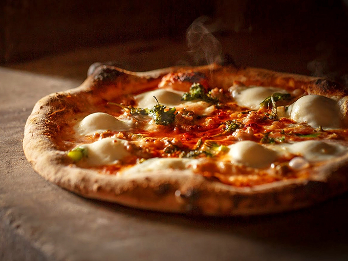 Steam rising from perfectly charred crust, this pizza looks like it just graduated from the Neapolitan School of Pizza Excellence.
