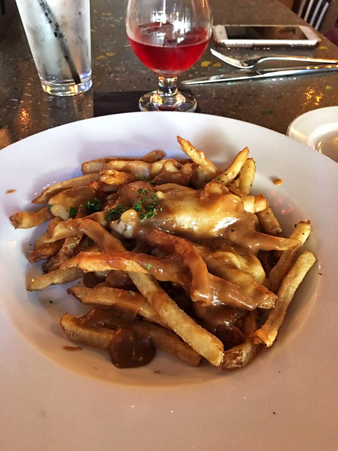 Golden fries swimming in rich gravy and melted cheese curds - this is what comfort food dreams are made of.