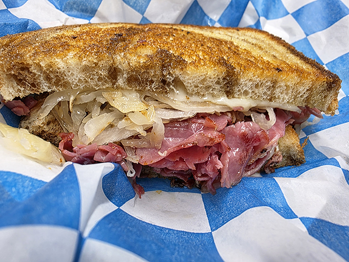 Behold the classic Reuben in all its glory, with corned beef piled high, sauerkraut adding tang, and rye bread grilled to crispy perfection that'll make you question every sandwich you've ever eaten.