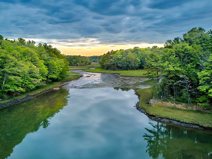 Nature's mirror: The Piscataqua River reflects the sky in perfect symmetry, framed by Maine's signature pine-lined shores.