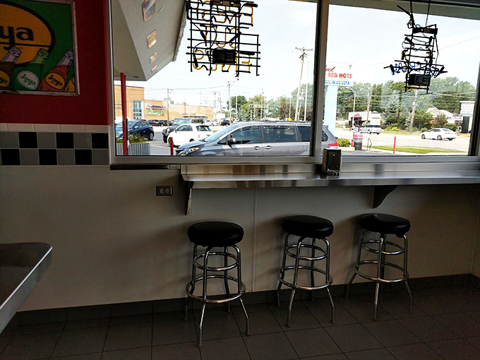 Chrome stools at the window counter offer front-row seats to Des Plaines life passing by, perfect for people-watching between bites.
