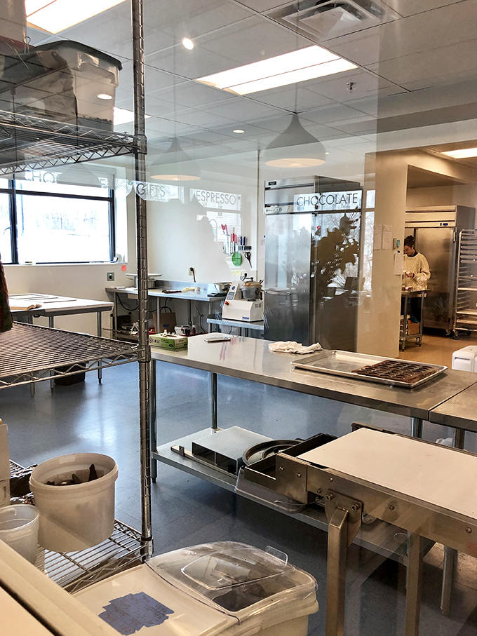 Behind the scenes of sweetness! This pristine workspace is where NU Chocolat's magicians conjure up their delectable creations. Wands optional, taste buds required!