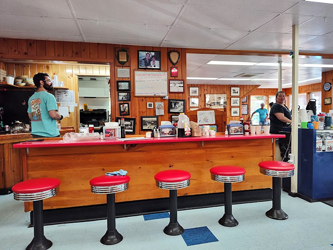 The counter, with its cherry-red stools and photo-lined walls, is where local stories are shared over steaming cups of coffee.