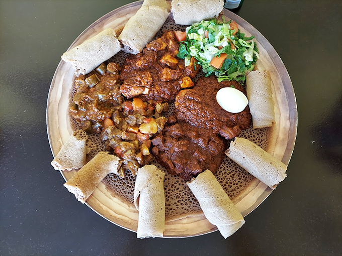 This isn't your average Maine stew! Rich, spicy zigni surrounds perfectly cooked eggs, while injera stands ready for scooping duty.