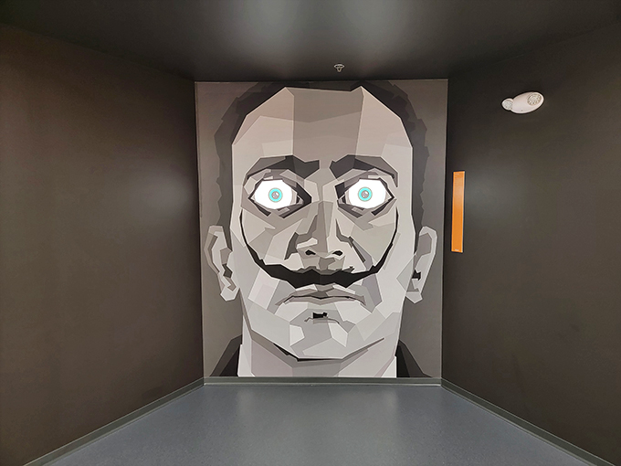 Talk about a staring contest! This larger-than-life face will have you feeling like you've wandered into a surrealist's fever dream. Don't blink, or you might miss the illusion!