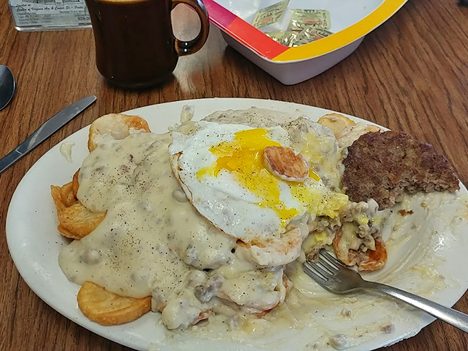 Holy gravy train! This plate's got more layers than a Shakespeare play - biscuits, eggs, and a river of gravy that'll make you weak in the knees.