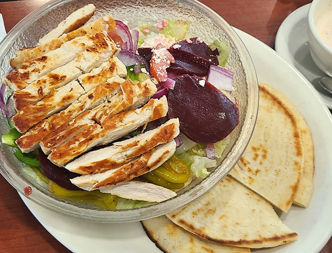 A Greek salad that could make Zeus jealous! Crisp veggies, tangy feta, and grilled chicken create a Mediterranean masterpiece right here in Michigan.