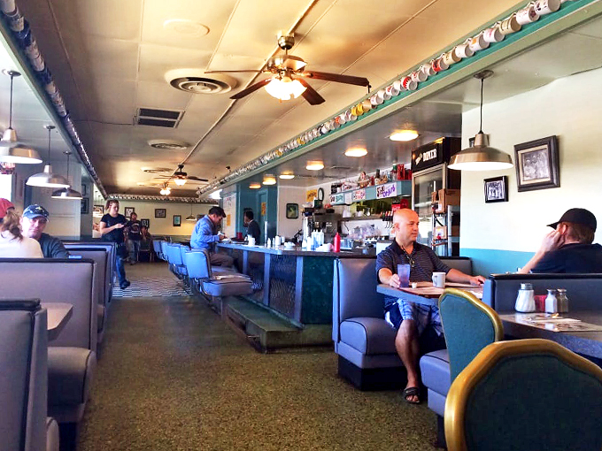 Time-worn booths and a collection of coffee mugs tell stories of morning rituals and weekend gatherings in this beloved diner.