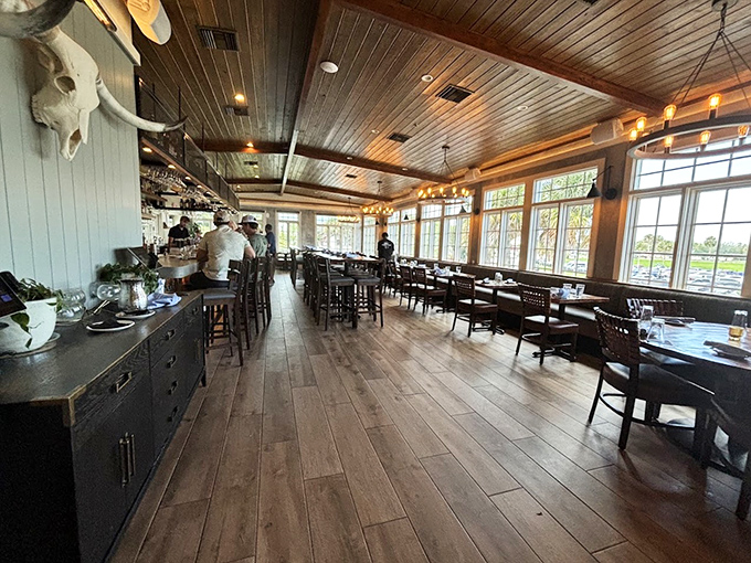 Rustic chic meets coastal cool in this airy dining room. With windows for days and a ceiling that whispers 