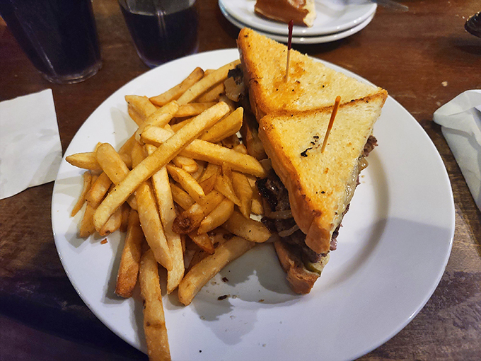 This isn't just a sandwich, it's a flavor explosion. Golden-grilled bread hugs a juicy patty, melty cheese, and crispy fries &ndash; comfort food that speaks all languages. Photo credit: Cameron Lennox