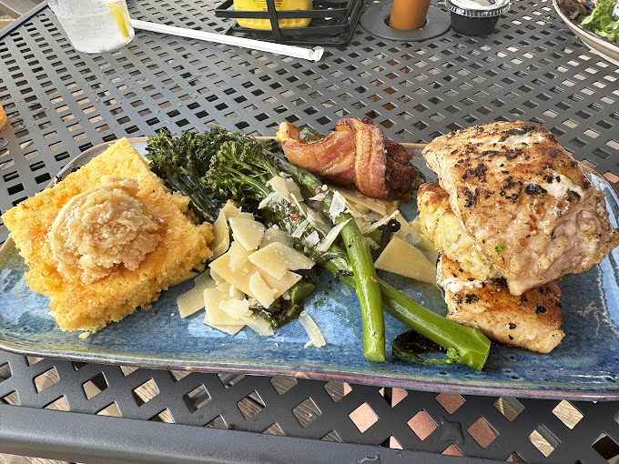 A feast fit for Poseidon himself! This platter showcases the kitchen's prowess – from perfectly grilled fish to cornbread that would make your grandma jealous. Photo credit: John Schumann