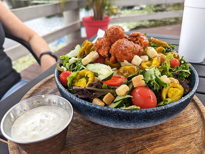 Who said healthy can't be heavenly? This salad's got more layers than a Florida summer wardrobe, topped with crispy chicken that's anything but foul. Photo credit: Angel C