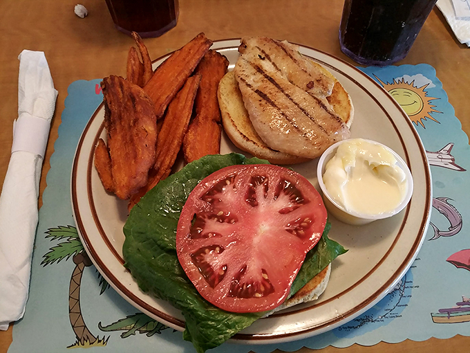 Who needs a fancy schmancy burger when you can have this beauty? Grilled perfection meets garden-fresh toppings, all nestled in a bun that's softer than a Florida sunset. Photo credit: Anette Mcgee