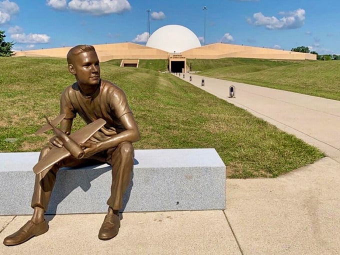 Dreaming of the stars? This bronze astronaut seems ready to trade his airplane for a rocket ship.