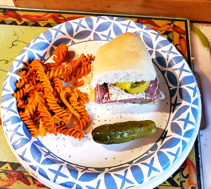 Behold, the holy trinity of lunchtime bliss: A hearty sub, zesty pasta salad, and the crunchiest pickle this side of dill-lightful.