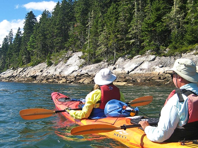 Serenity now! These kayakers are living the dream, gliding through nature's masterpiece. Can you smell the salt air?